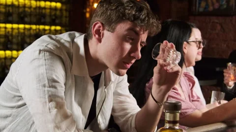 Drunk man leans on bar counter and looks... | Stock Video | Pond5