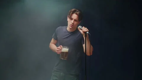 Drunk man singing on stage and drinking ... | Stock Video | Pond5