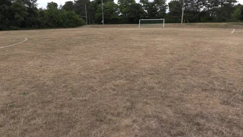 Dry soccer field and brown grass and dro... | Stock Video | Pond5