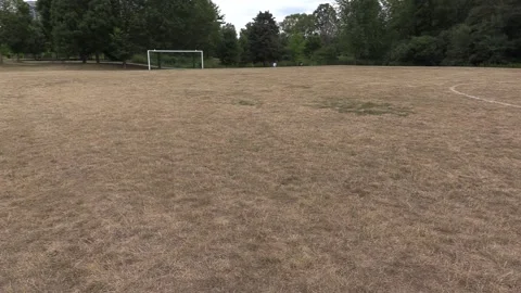 Dry soccer field and brown grass and dro... | Stock Video | Pond5