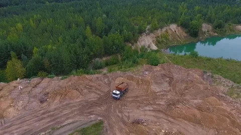 Dump truck carries sand on the backgroun... | Stock Video | Pond5
