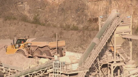 Dump truck unloads stone into a hopper f... | Stock Video | Pond5