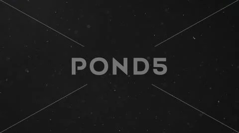 Dust particles float in neutral light on black background Stock Image ...