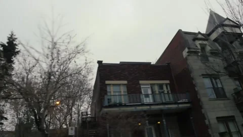 Dutch angle tracking shot of old buildin... | Stock Video | Pond5