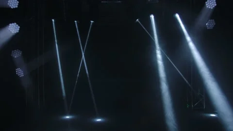 Dynamic white beams of stage light on bl... | Stock Video | Pond5