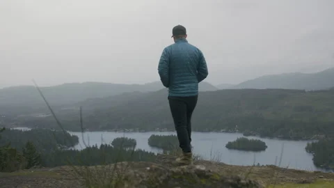 With each step, a man ascends the mounta... | Stock Video | Pond5