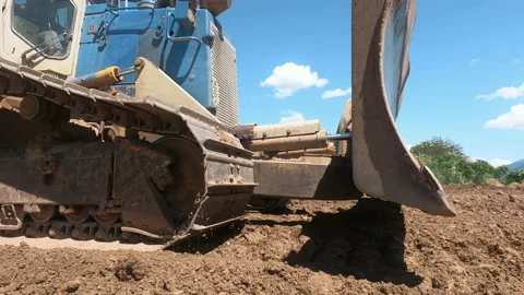 Earth movers leveling ground on road con... | Stock Video | Pond5