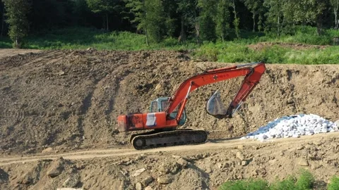 Earthmoving equipment. A red excavator i... | Stock Video | Pond5