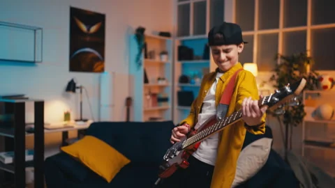 Eccentric teen boy playing bass guitar a... | Stock Video | Pond5