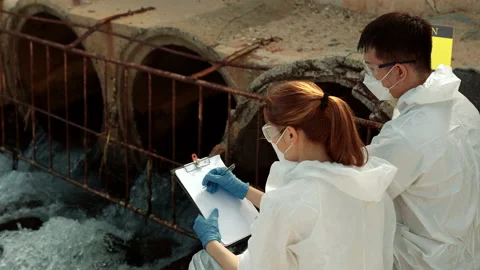 Ecologists sample water contaminated wit... | Stock Video | Pond5