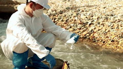 Ecologists sample water contaminated wit... | Stock Video | Pond5