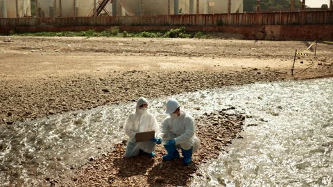 Ecologists sample water contaminated wit... | Stock Video | Pond5