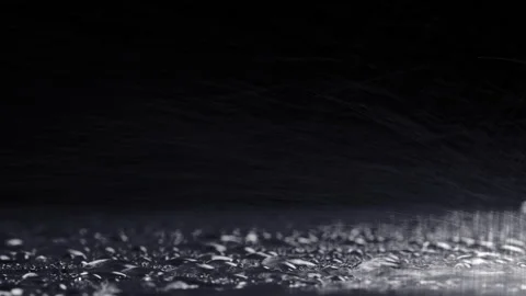 The effect of water drops falling on the... | Stock Video | Pond5