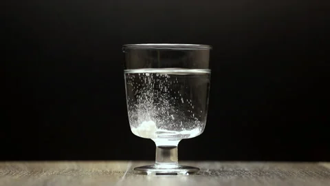 Effervescent in granules dropped into a ... | Stock Video | Pond5