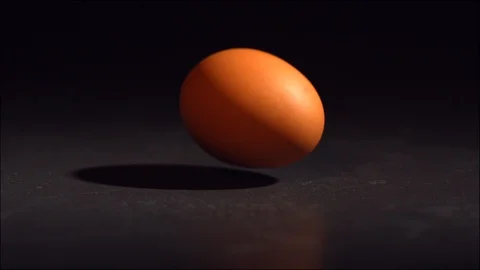 Egg falling and breaking in slow motion... | Stock Video | Pond5