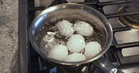 Eggs in boiling water to make boiled egg... | Stock Video | Pond5