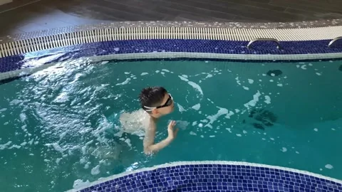 Eight-year-old boy learning to swim in i... | Stock Video | Pond5