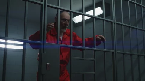 Elderly criminal looks at barred window,... | Stock Video | Pond5