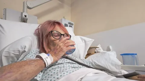 Elderly female patient drinking water in... | Stock Video | Pond5