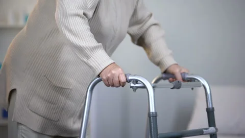 Elderly lady using walking frame, rehabi... | Stock Video | Pond5