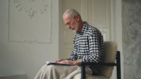 An elderly man falls asleep while sittin... | Stock Video | Pond5