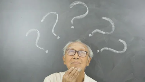 Elderly man looking at question marks ov... | Stock Video | Pond5