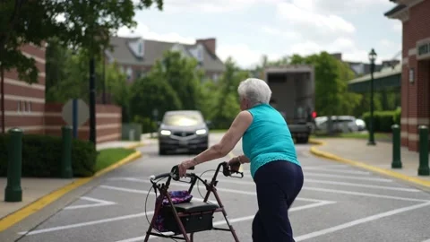 Elderly senior woman pushing a walker at... | Stock Video | Pond5