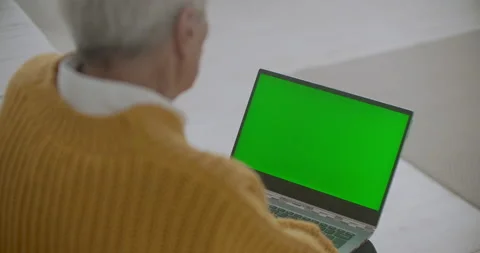 An elderly woman looks at a monitor with... | Stock Video | Pond5