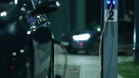 Electric car is being charged at an EV v... | Stock Video | Pond5