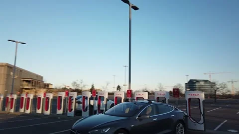 Electric Cars at Tesla Charging Station ... | Stock Video | Pond5