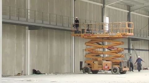 Electric Scissor Lift going up with a wo... | Stock Video | Pond5
