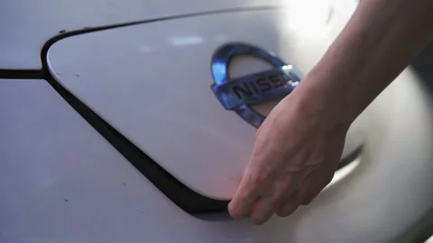 Electric vehicles are put on charge. Han... | Stock Video | Pond5