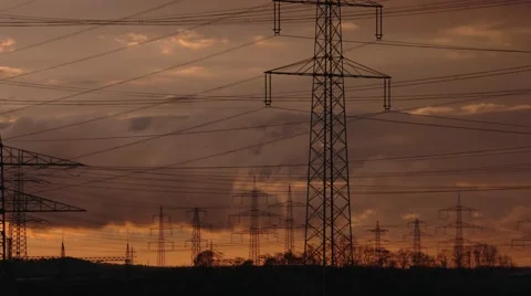 Electrical towers in front of a red sky ... | Stock Video | Pond5