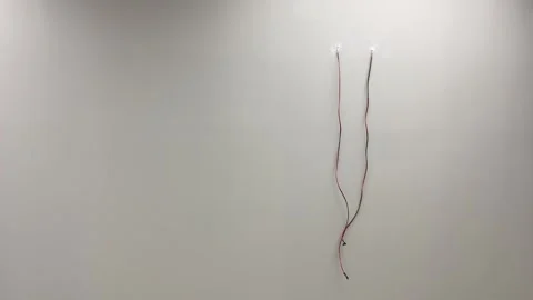 Electrical wire cable hanging from grey ... | Stock Video | Pond5