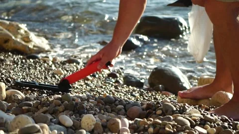 An electronic metal detector on the pebb... | Stock Video | Pond5