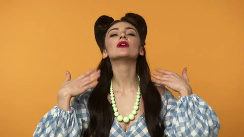 Elegant pin up woman checking hairstyle ... | Stock Video | Pond5