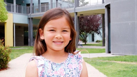 Elementary schoolgirl smiling to camera... | Stock Video | Pond5