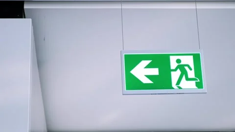 Emergency exit sign. The left arrow dire... | Stock Video | Pond5