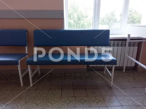Photograph: Empty blue chair alignment in a hospital waiting room ...