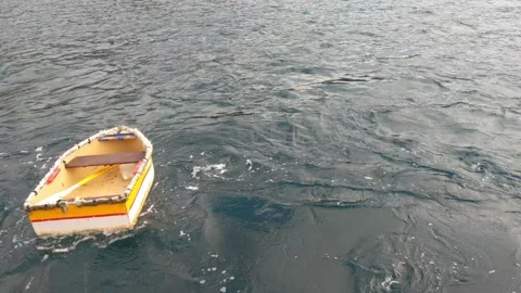 Empty boat in the ocean or sea. Waves ro... | Stock Video | Pond5
