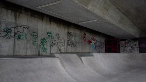 Empty indoor skate park with graffiti on... | Stock Video | Pond5