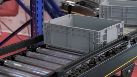 Empty plastic crate boxes moving on conv... | Stock Video | Pond5