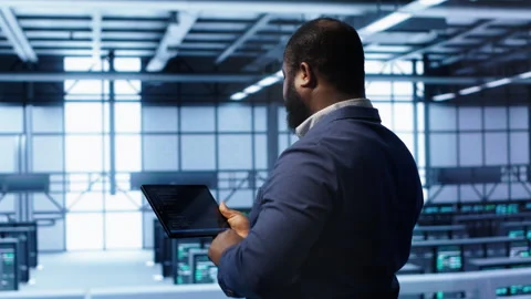 Engineer in data center fixing errors af... | Stock Video | Pond5