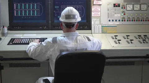 engineer sits in a chair and controls a ... | Stock Video | Pond5