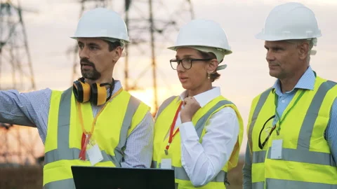 Engineers in uniform work with laptop, s... | Stock Video | Pond5
