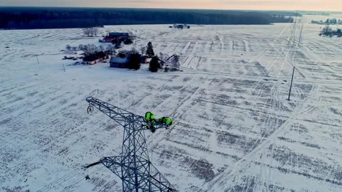 Engineers working high on the power line... | Stock Video | Pond5