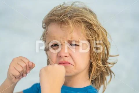 Photograph: Enraged kid boy with angry expression. Angry hateful little ...
