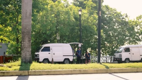 Establishing shot of two white vans used... | Stock Video | Pond5