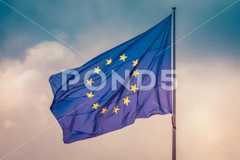 Photograph: European Union flag flying the wind in sky, concept of ...