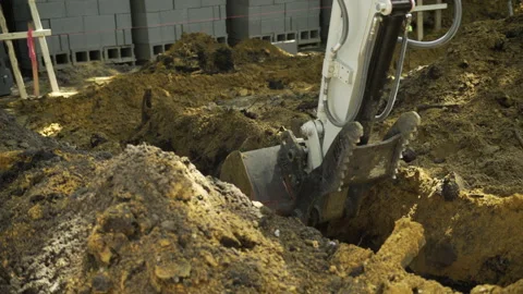 Excavator Bucket Scoops Dirt at Construc... | Stock Video | Pond5